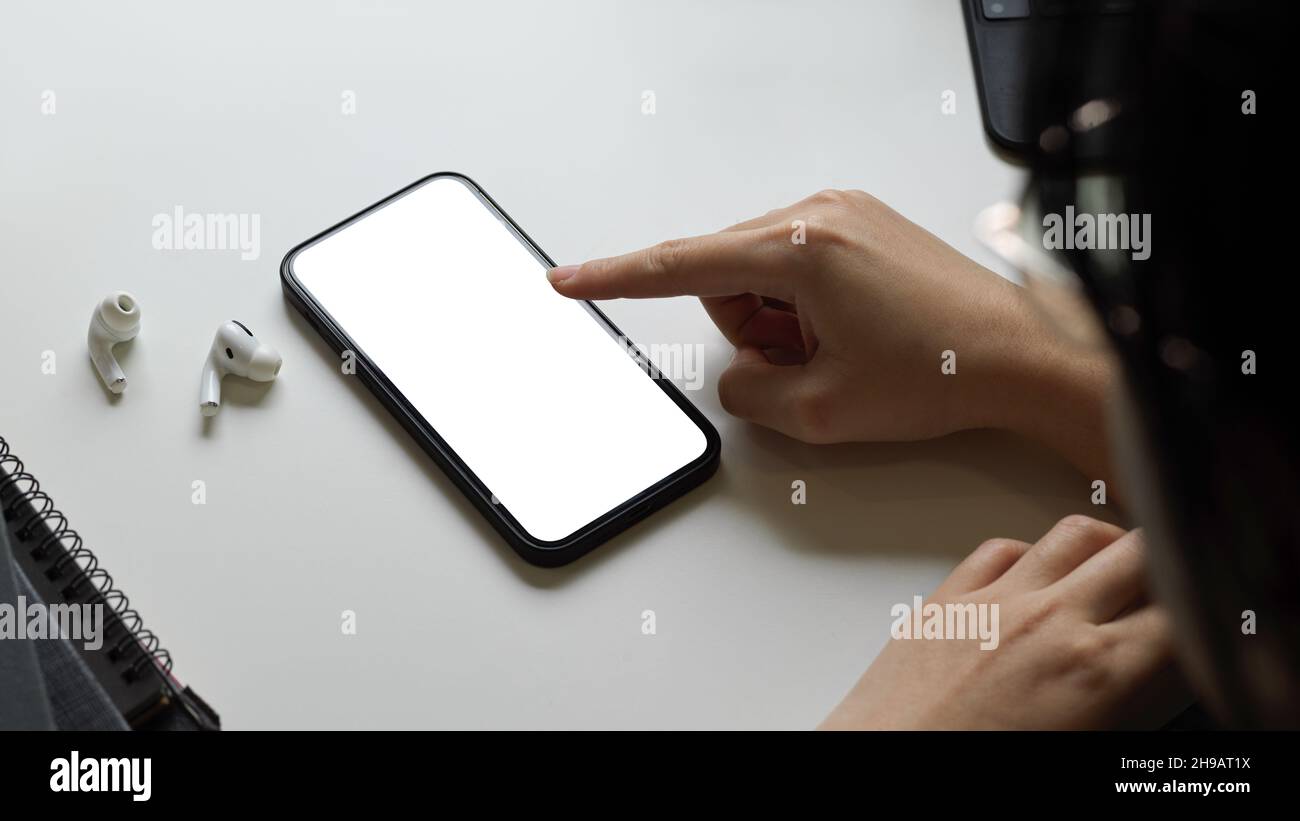 Close-up, a female pointing her finger on smartphone screen, touching ...