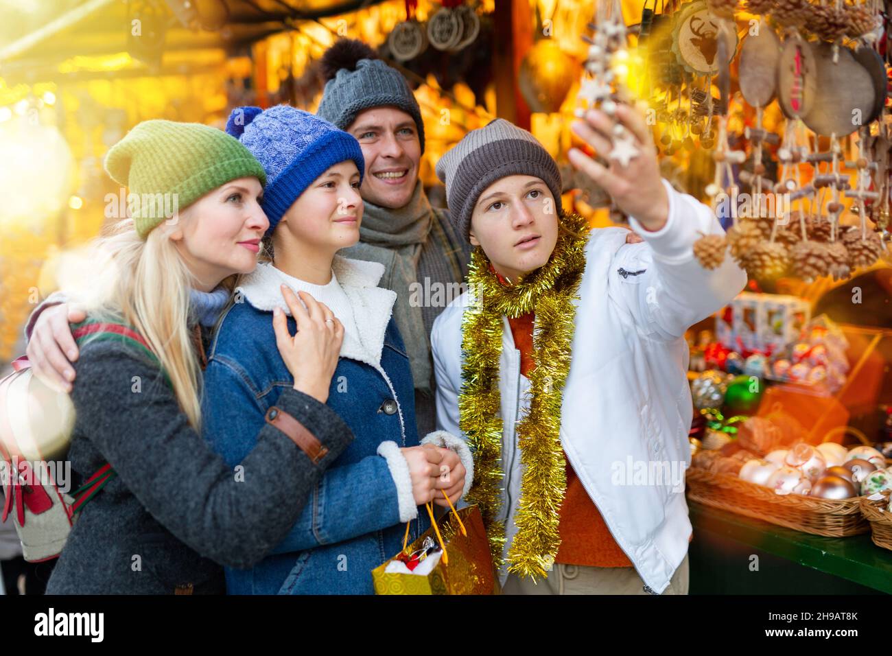 Happy family purchasing christmas decorations Stock Photo - Alamy