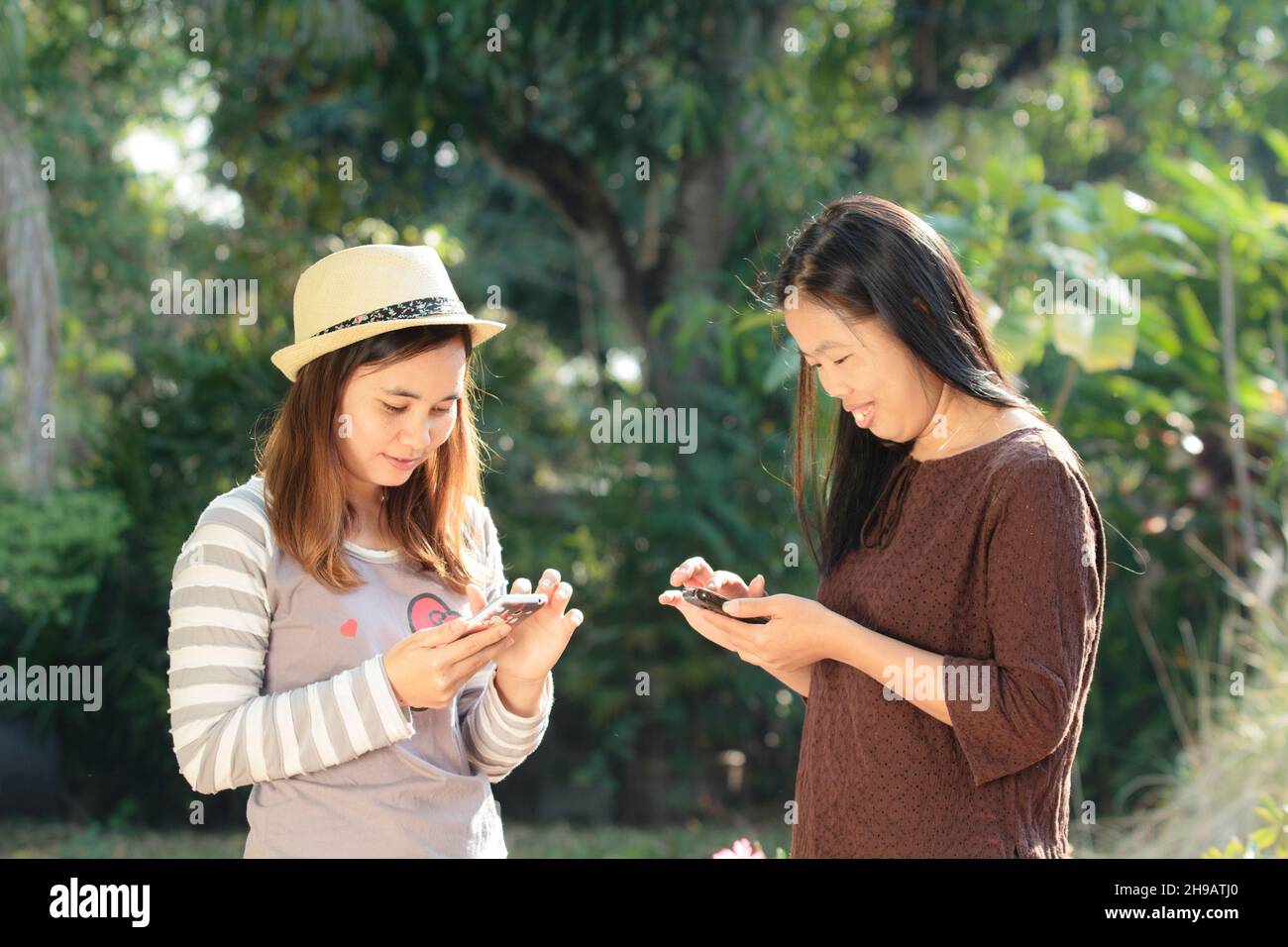 young asian women using a mobile phone Stock Photo - Alamy