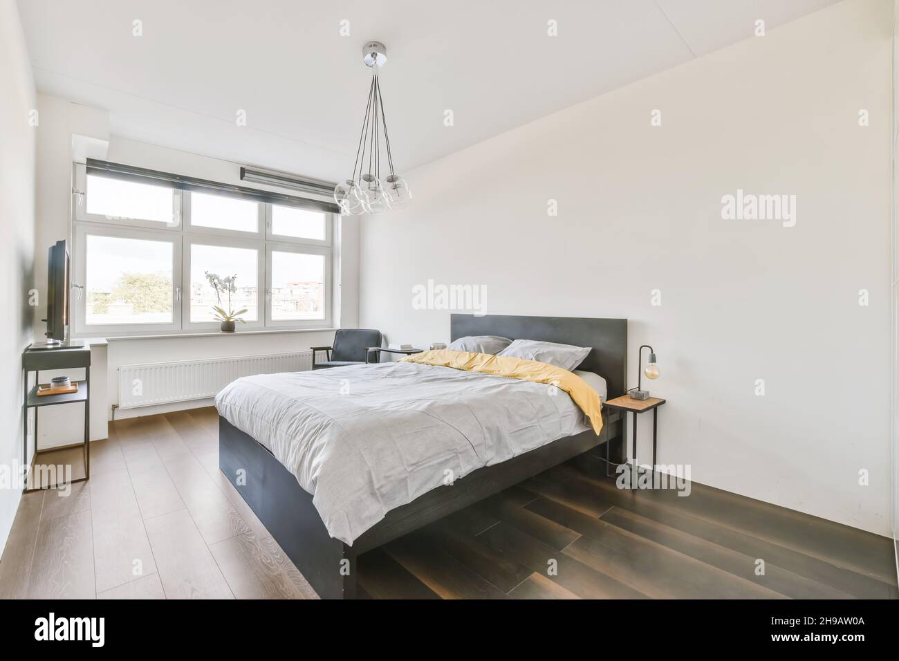 Attractive bedroom with resilient bed and designer chandelier Stock ...