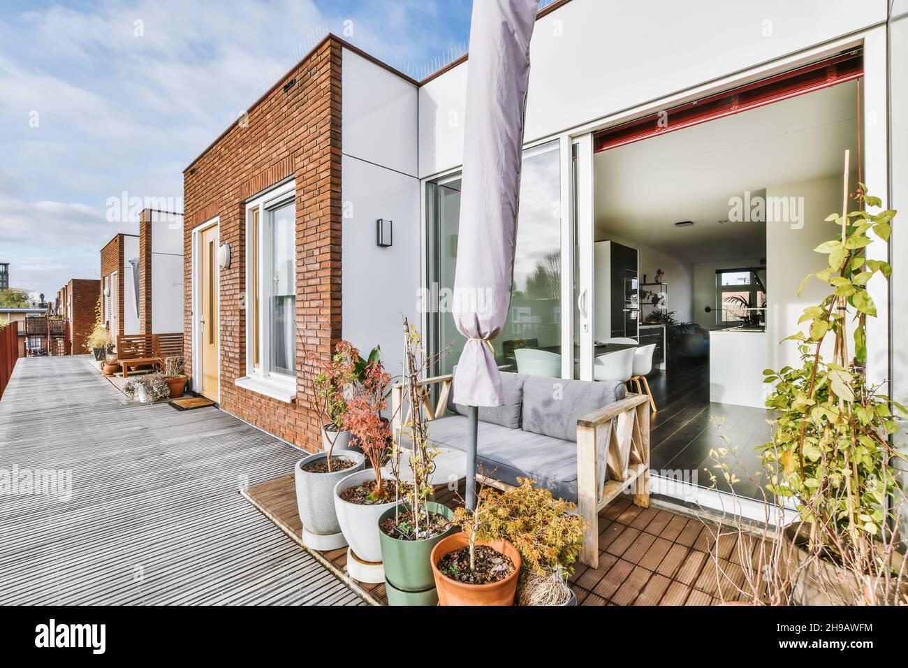 Attractive back of the apartment with open door and bench Stock Photo ...