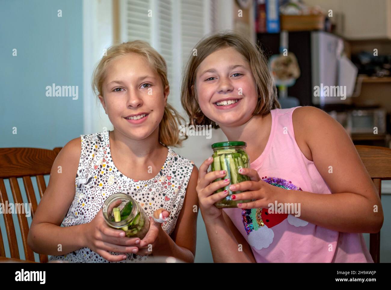 Proud sisters show off jars of freshly made pickles Stock Photo - Alamy