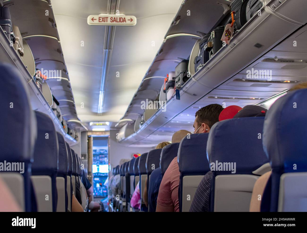A airplane crowded with people sits on the runway waiting for takeoff ...