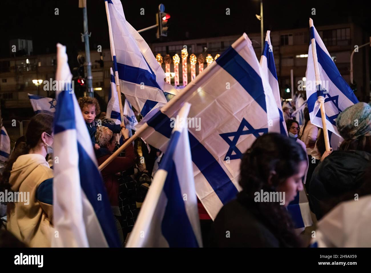 Participants hold flags during the celebrations. Israeli religious ...