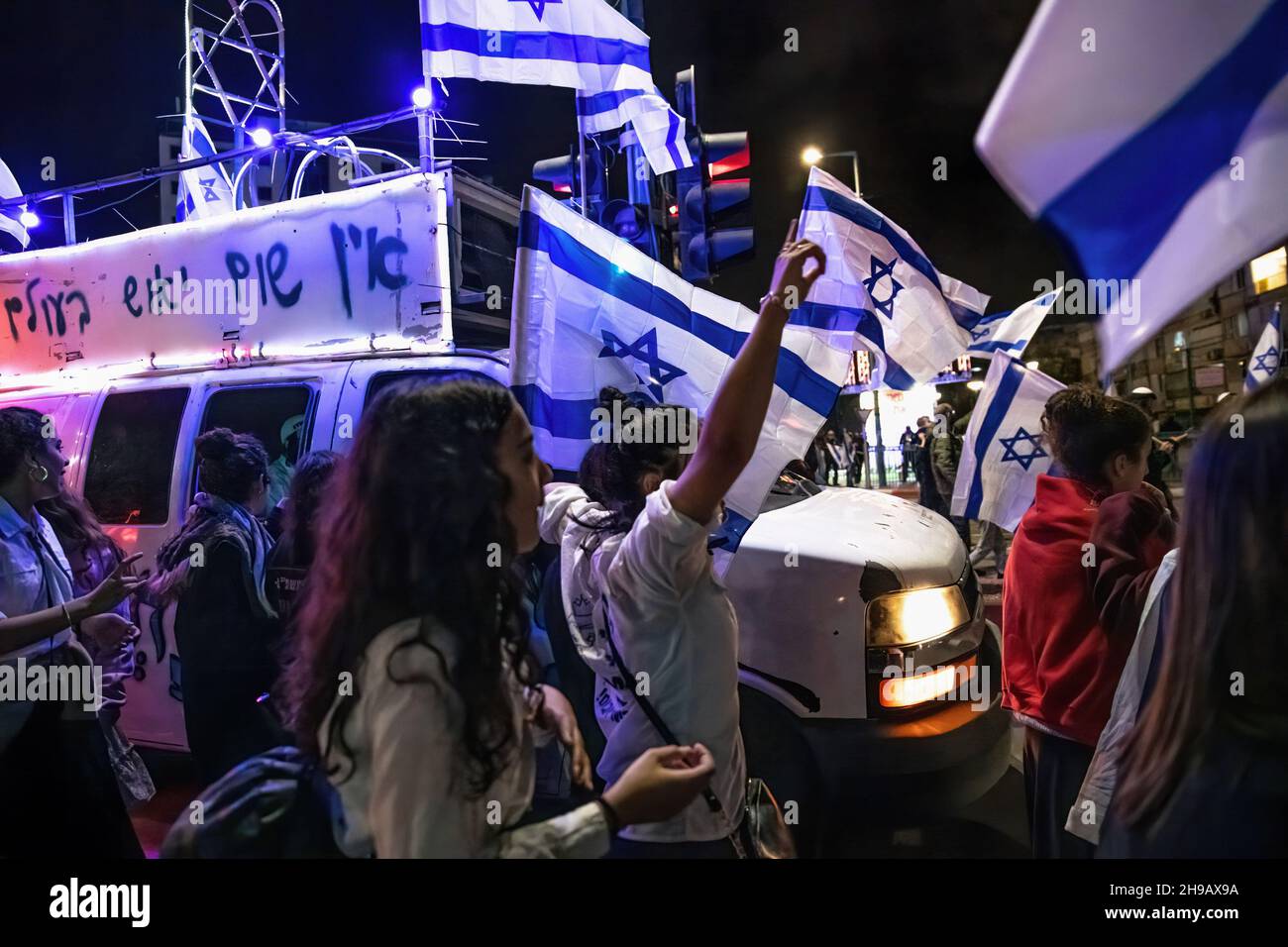 Participants hold flags during the celebrations. Israeli religious ...