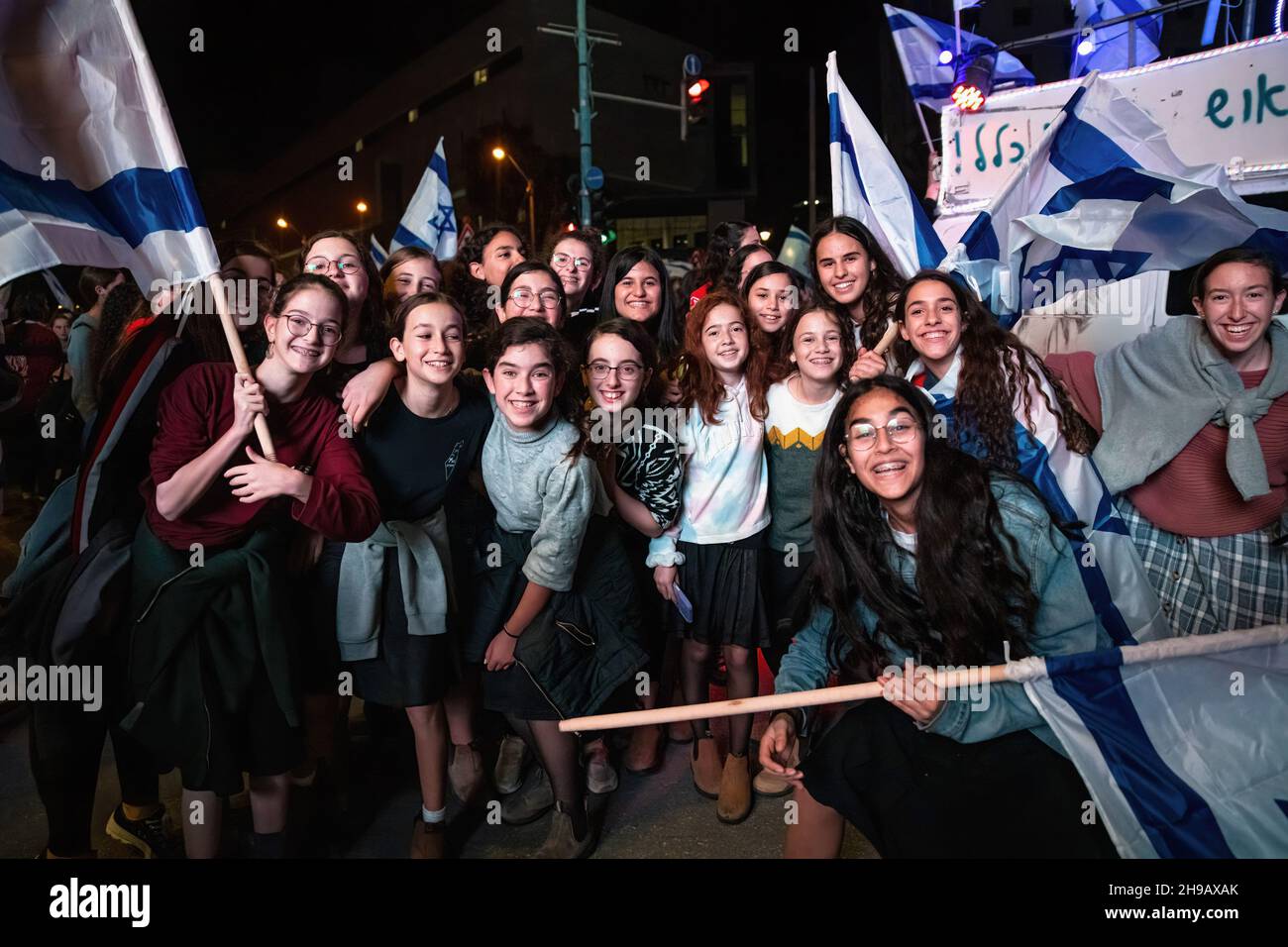 Participants hold flags during the celebrations. Israeli religious ...