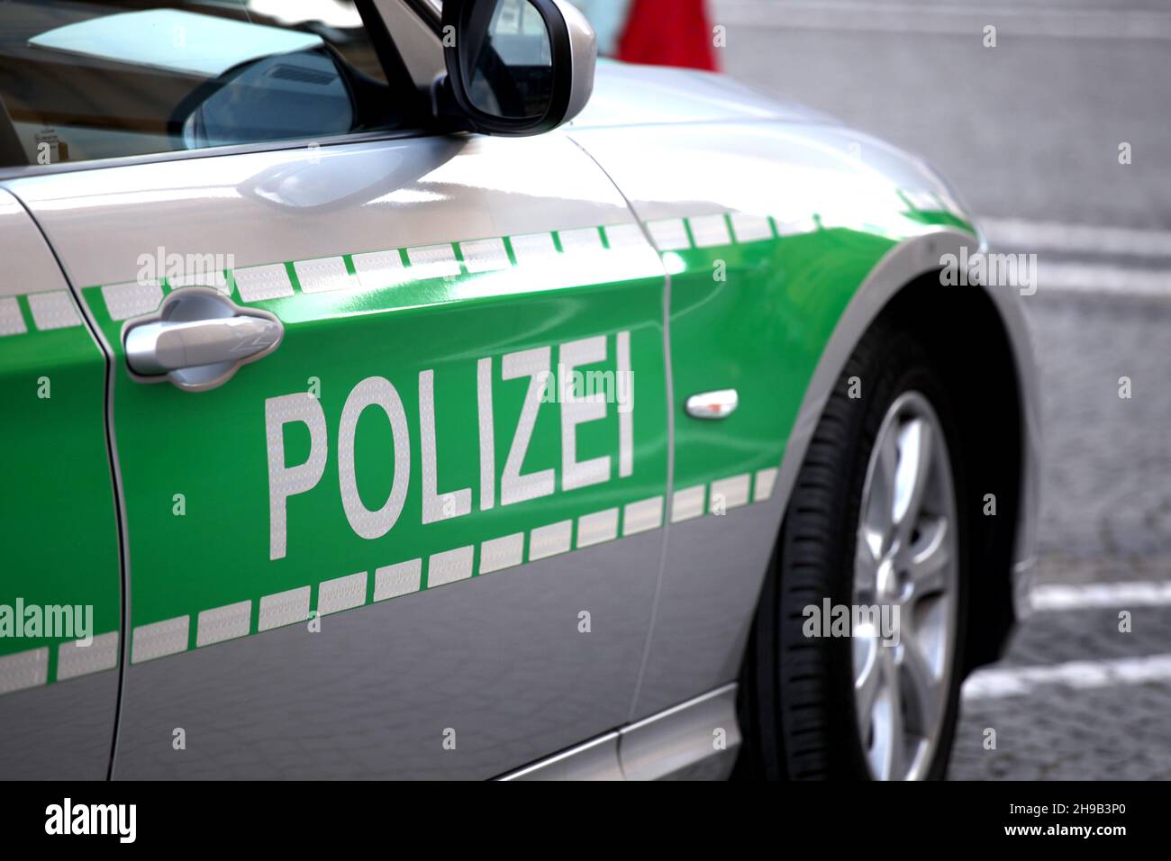 Silver police patrol car with green sticker - Photo Stock Photo - Alamy