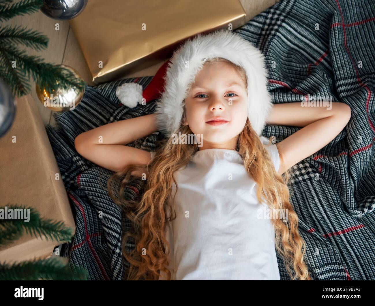 Happy girl lying under tree hi-res stock photography and images - Alamy