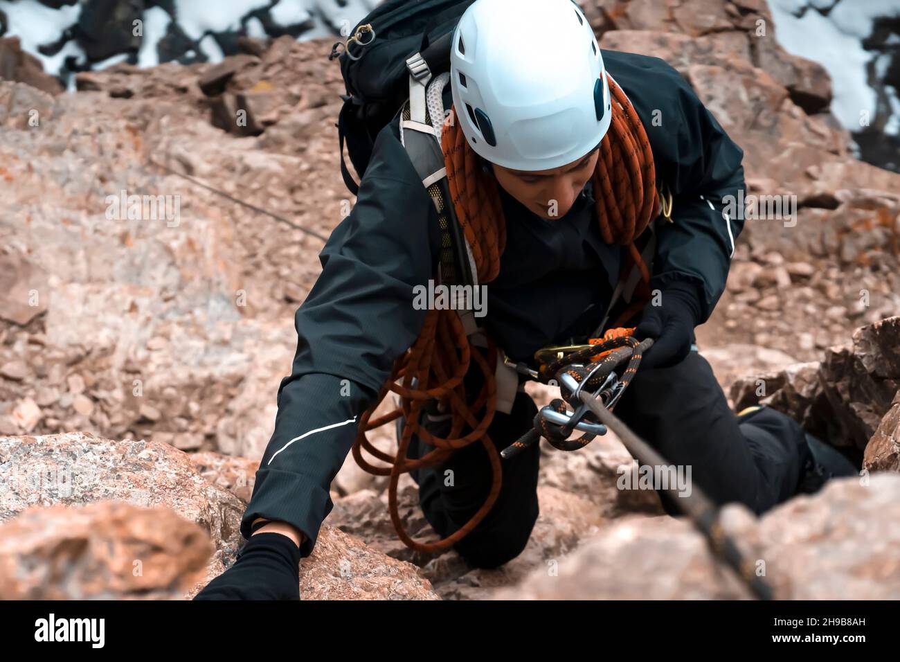 Climber is rappeling from the mountains summit Stock Photo - Alamy