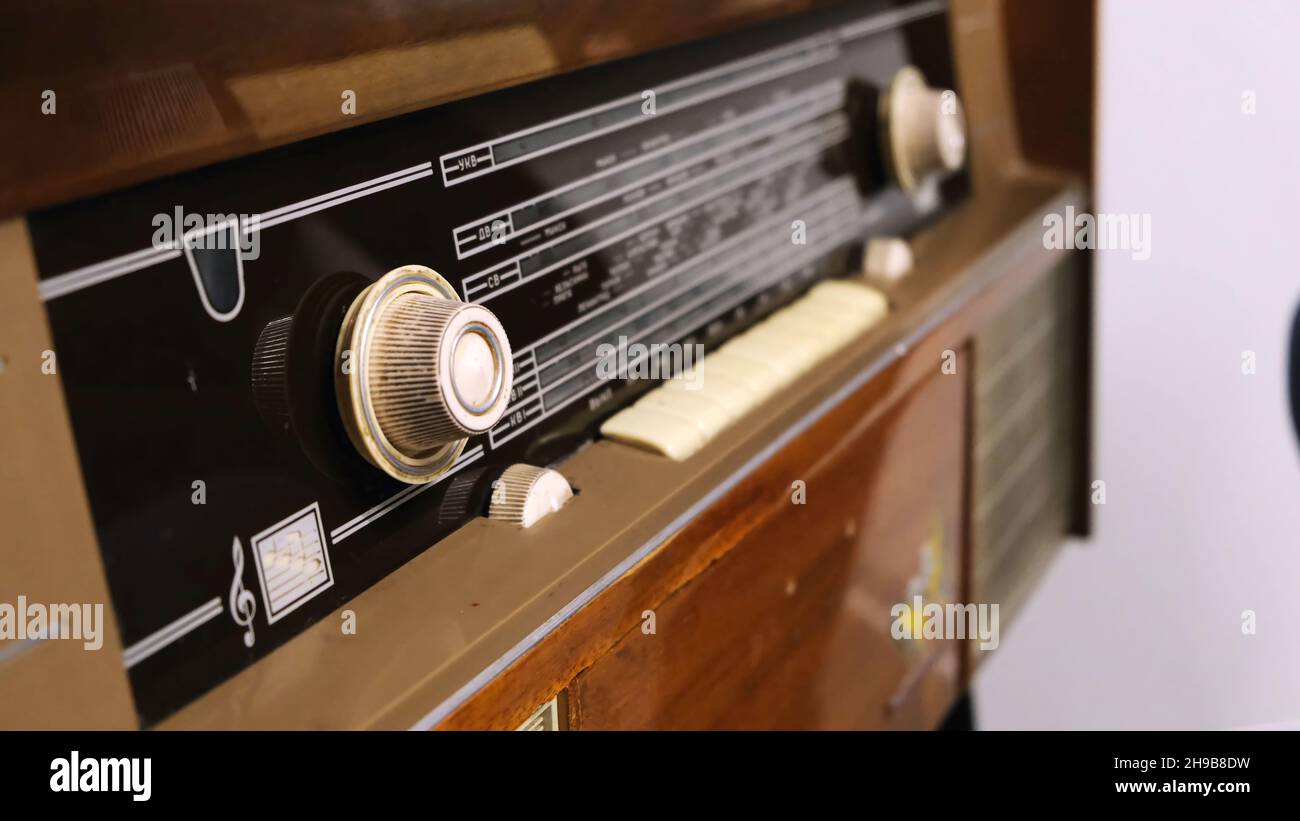 Close-up of man's hand rotating the knob on the old radio. Vintage ...
