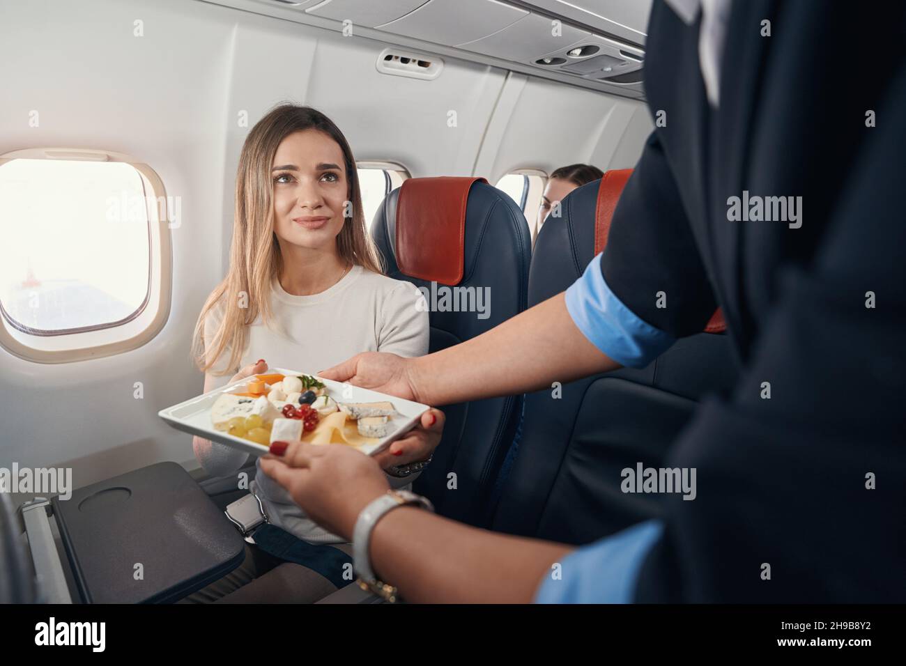 Thankful female getting her breakfast on airplane Stock Photo - Alamy