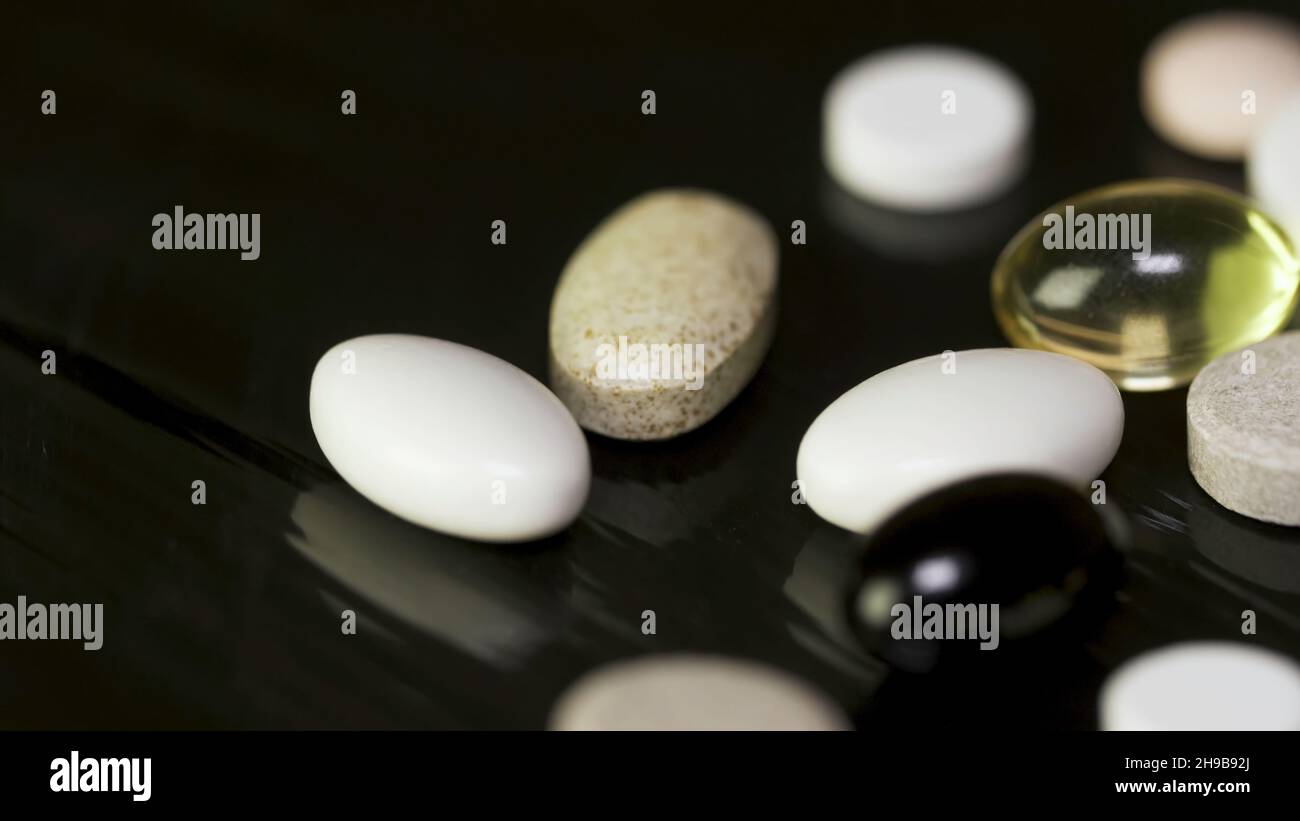 Pills spinning. Pile of several medicines. White tablets with pills on ...