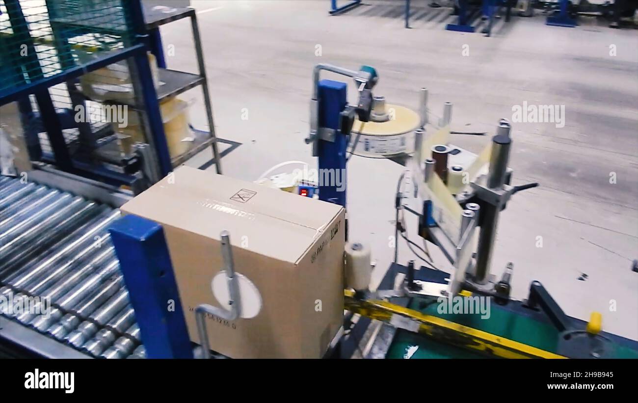 Cardboard boxes on conveyor belt in factory. Clip. Production line on ...