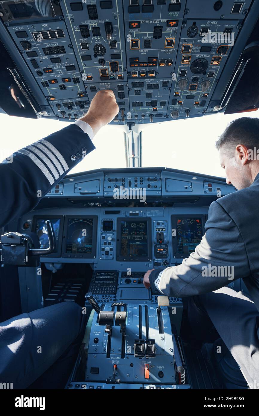 Plane captain toggling switch on cockpit control panel Stock Photo - Alamy