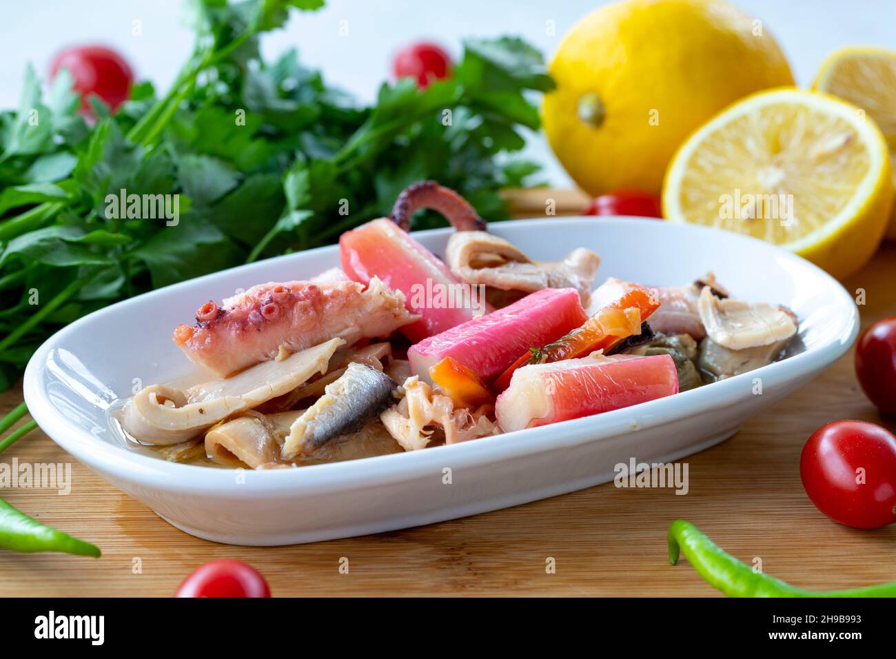 Seafood salad on wooden background. Seafood dishes. local name balık ...