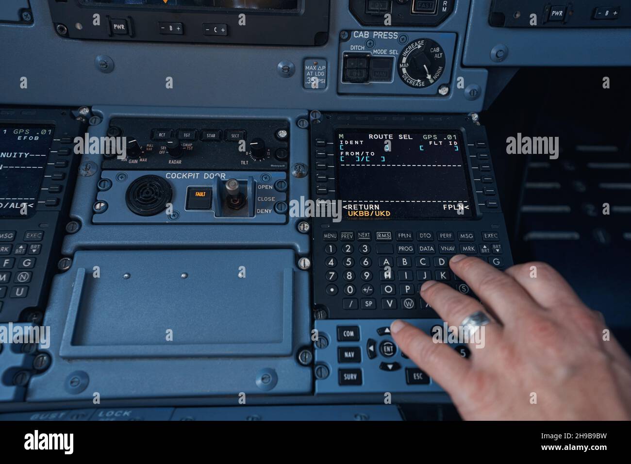 Airplane pilot typing route details into onboard computer inside ...