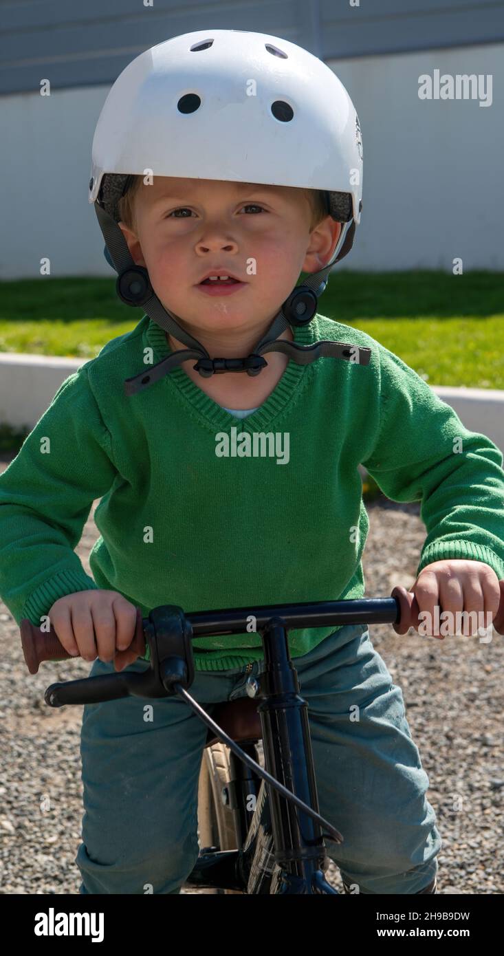 Cheerful little boy riding a bicycle Stock Photo - Alamy