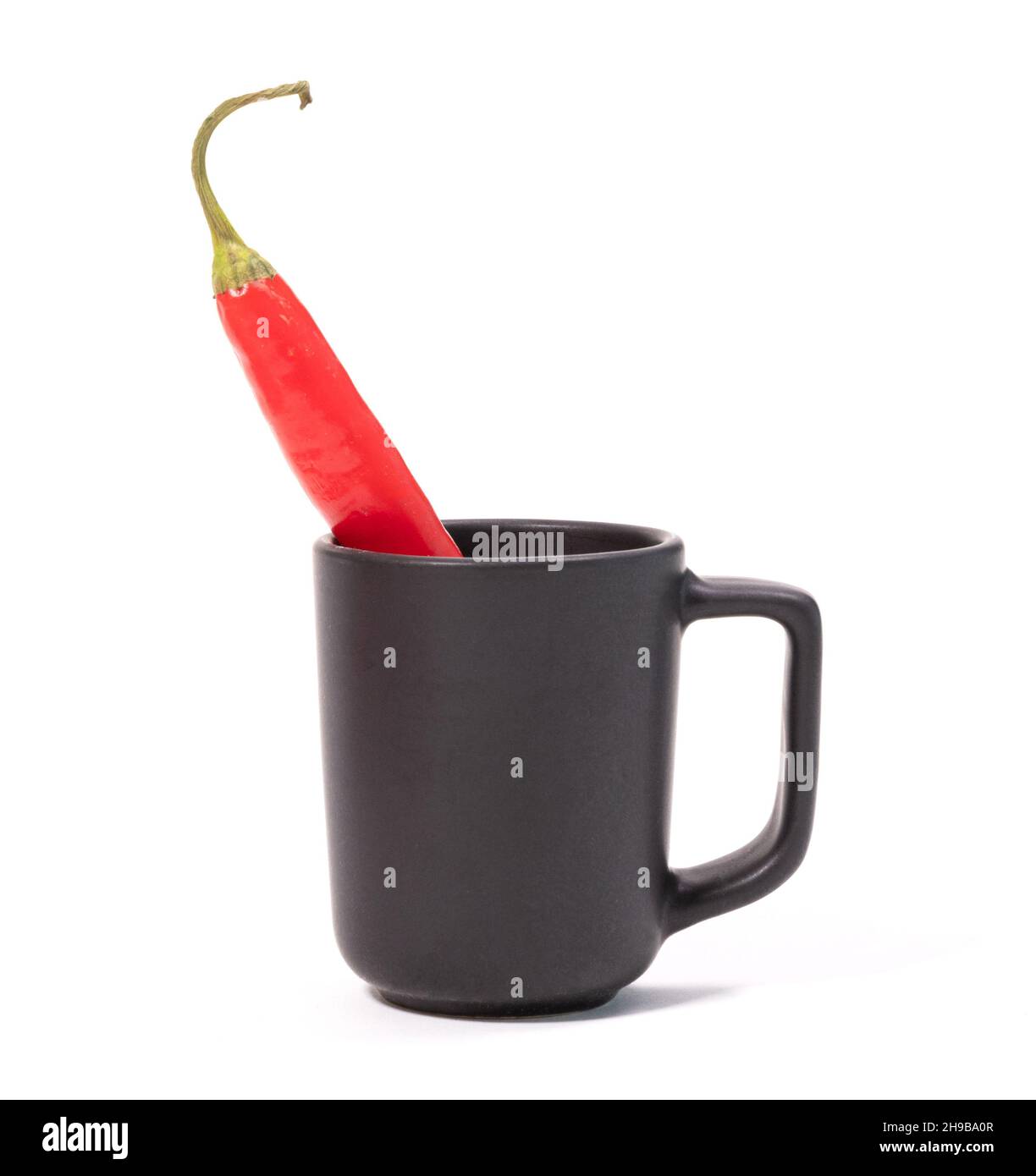 Red hot chili peppers in small coffee (espresso) mug, isolated on white ...