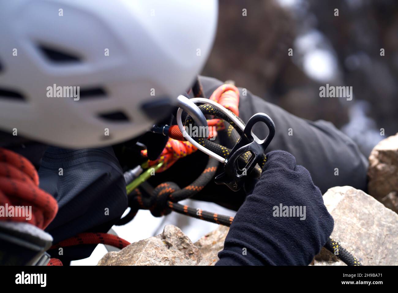 Climber is rappeling from the mountains summit Stock Photo - Alamy