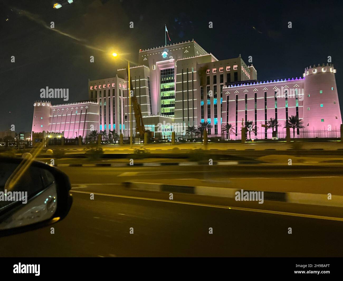night view of Ministry of Interior Office in Doha through Car window ...