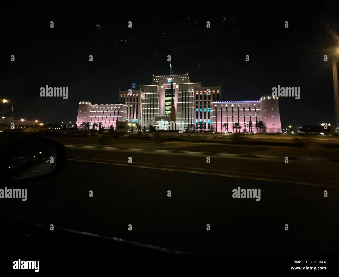night view of Ministry of Interior Office in Doha through Car window ...