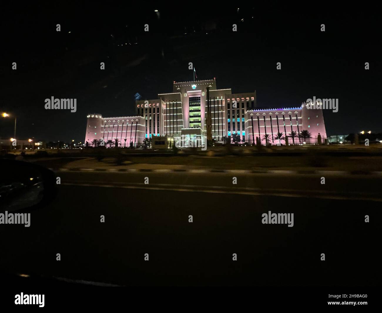 night view of Ministry of Interior Office in Doha through Car window ...