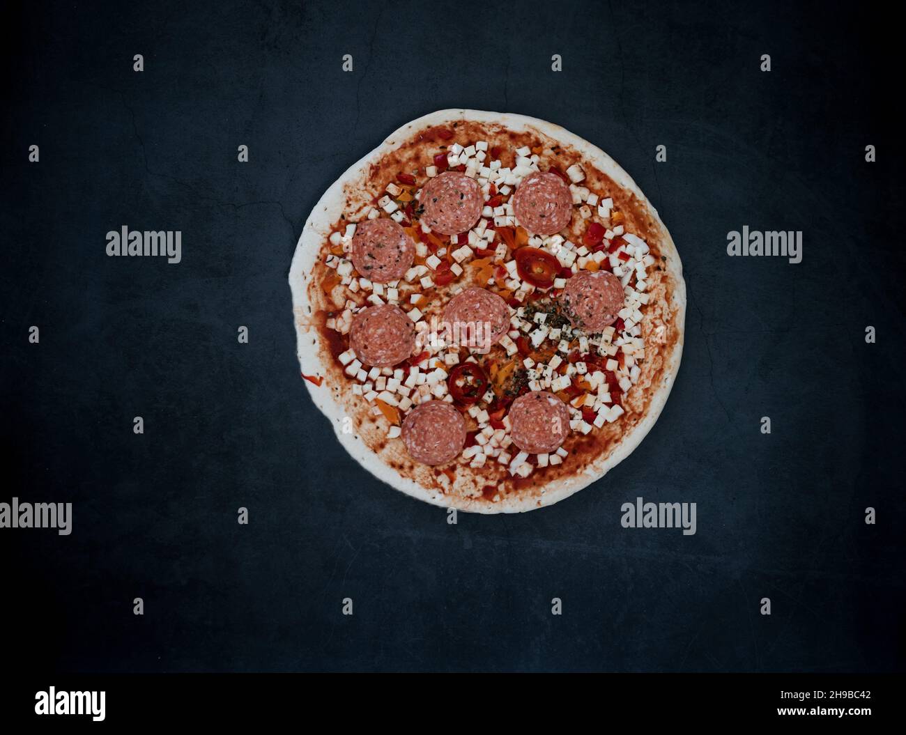 Raw Pizza on dark background. Original italian pepperoni pizza Stock ...