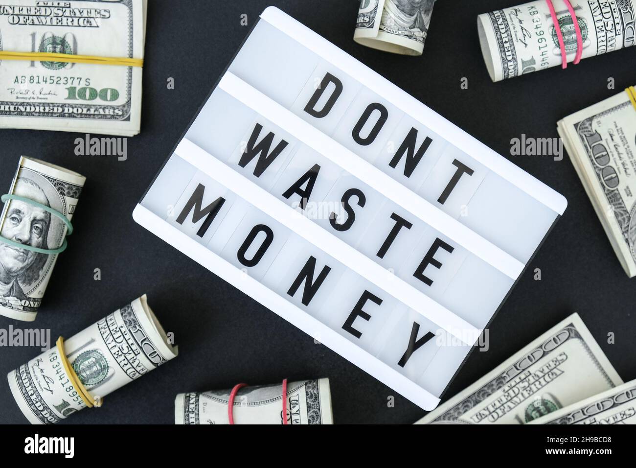 Lightbox board with word DONT WASTE MONEY in black letters around US ...