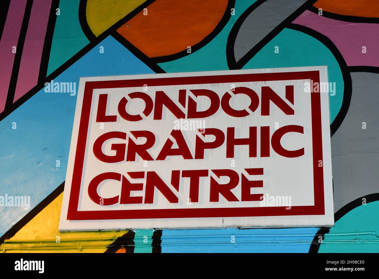 A sign on a white background with red writing for the London Graphic ...