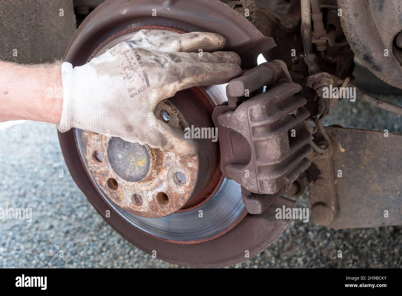 a Car mechanic repairing brakes on car Stock Photo - Alamy