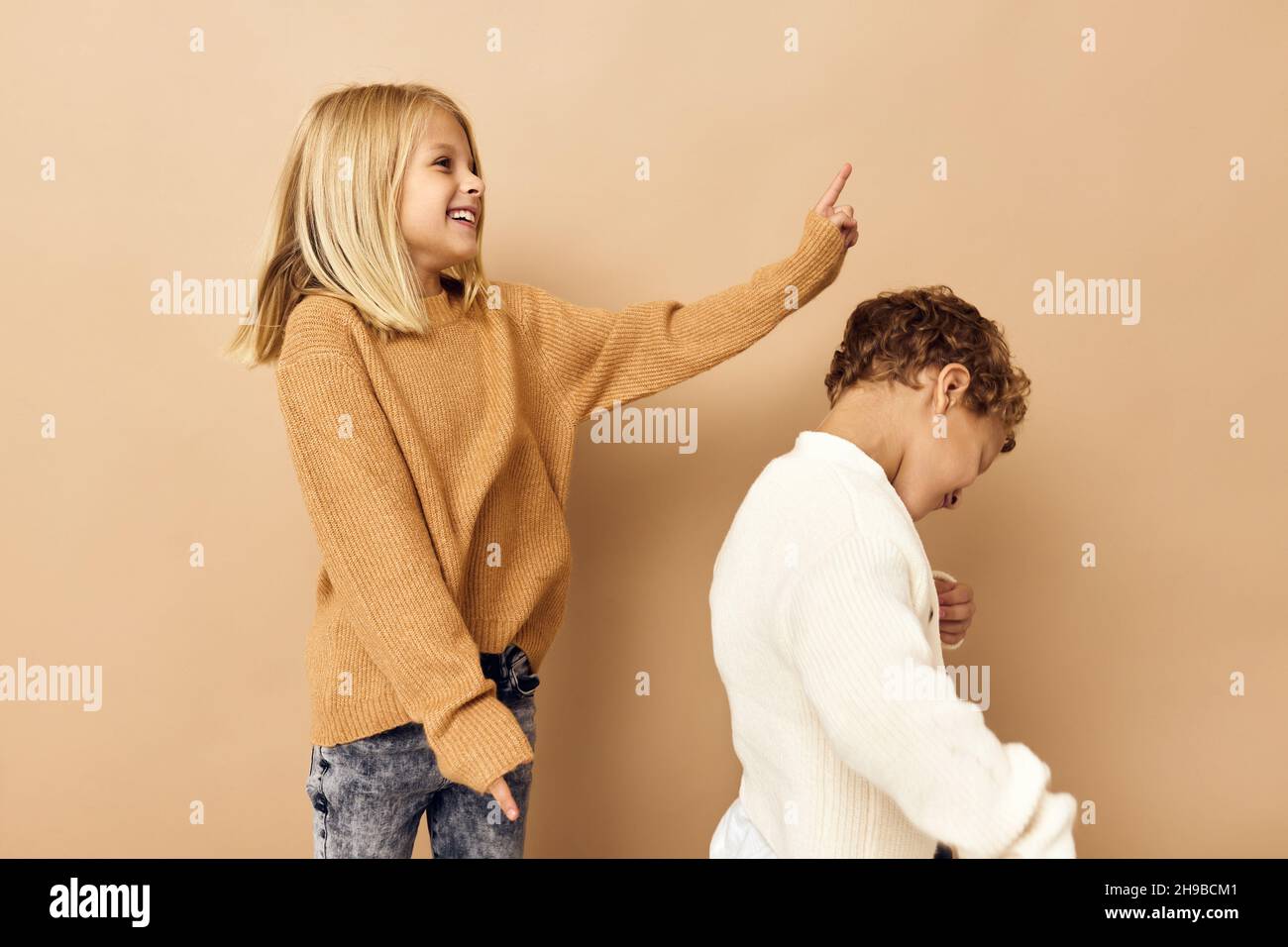 little girl and boy hug games smile friendship beige background Stock ...