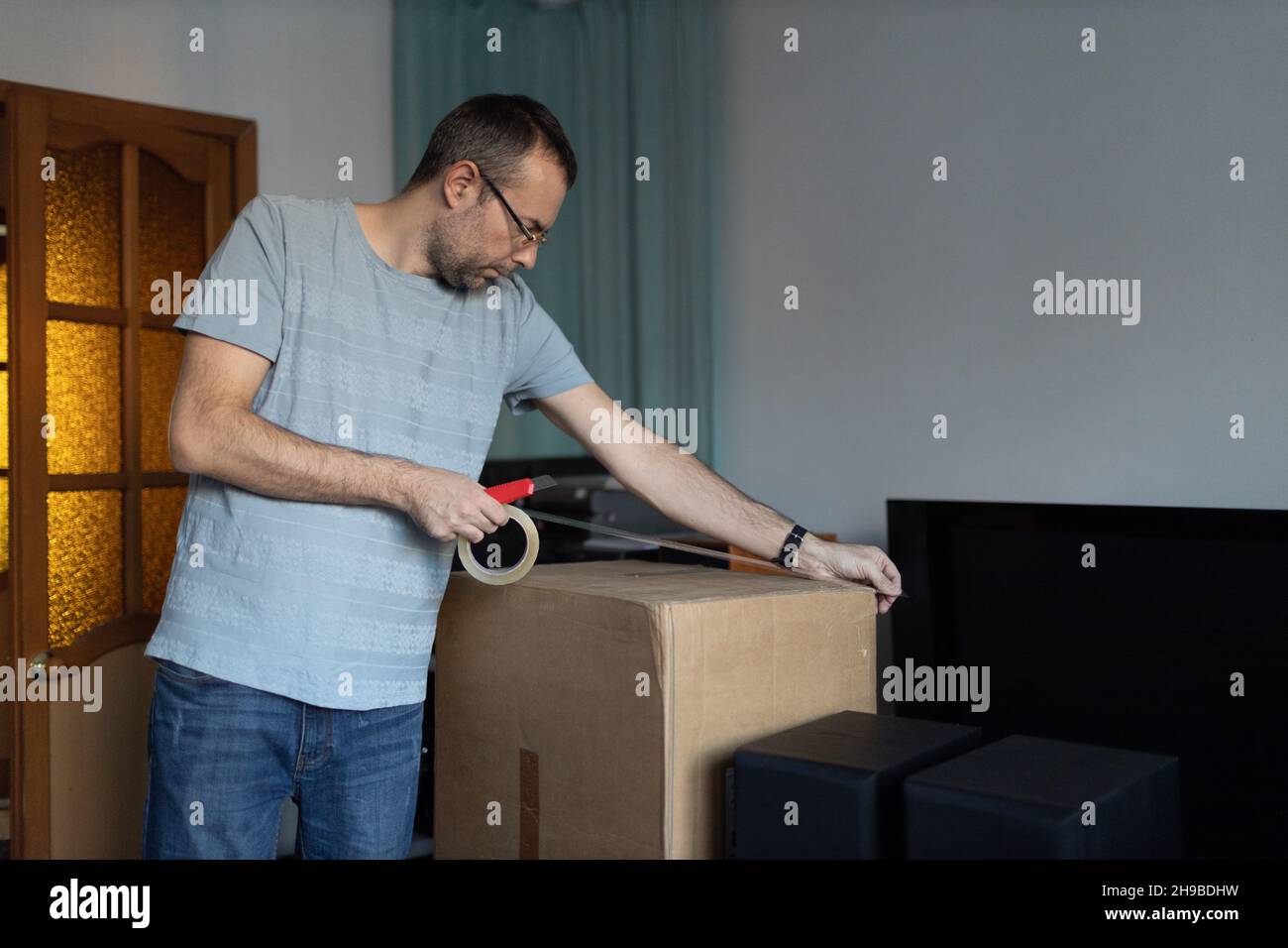 Adult man small business owner packing order box package shipping to ...