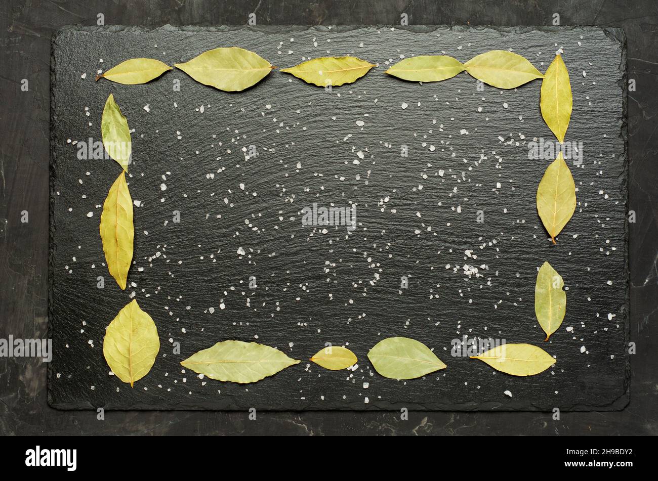 Spice. Bay leaves on a slate background with sea salt Stock Photo - Alamy