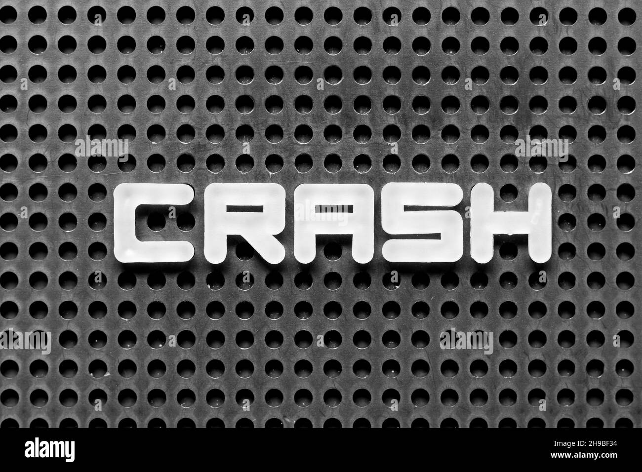 White alphabet letter in word crash on black pegboard background Stock ...