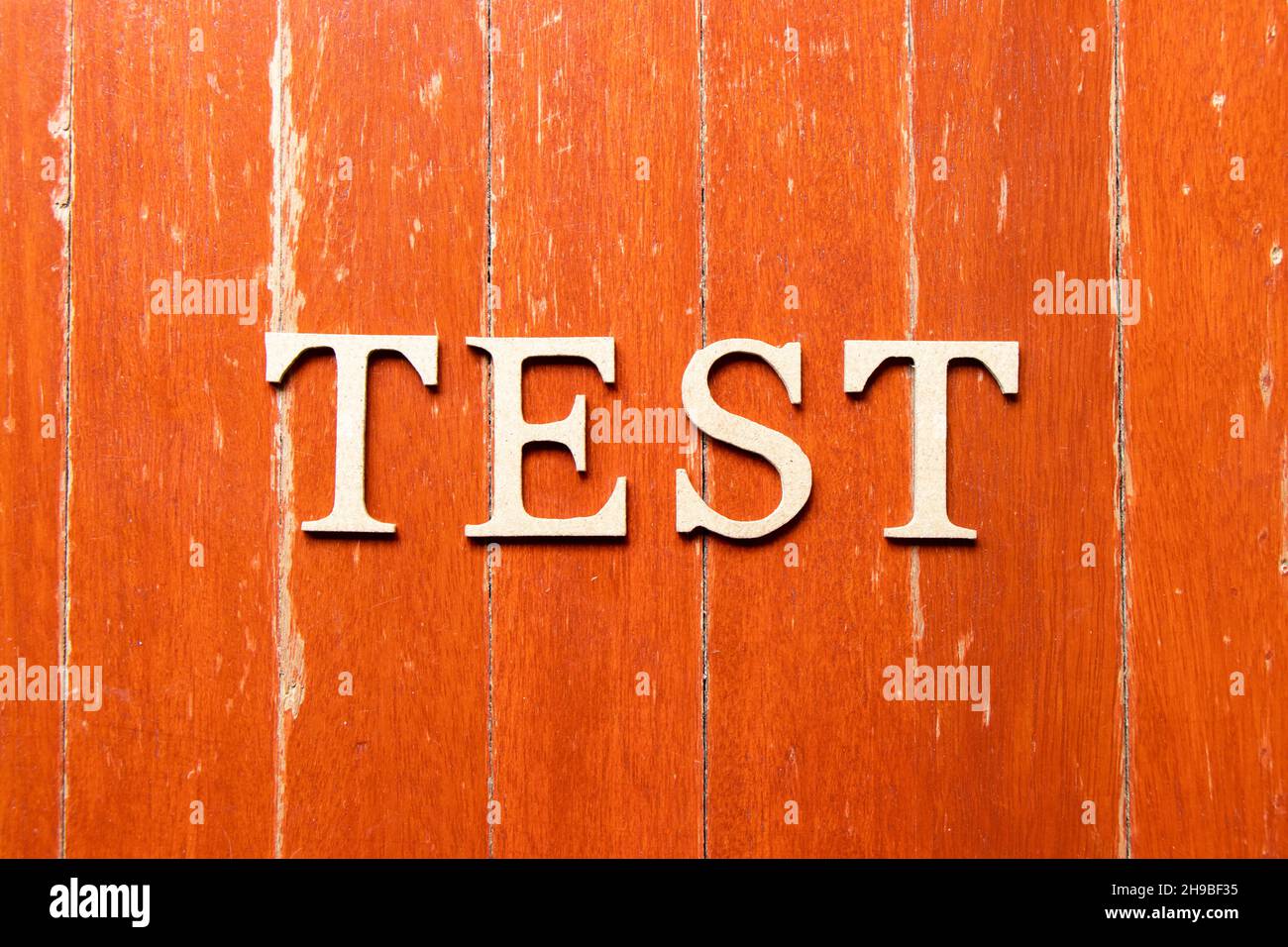 Alphabet letter in word test on old red color wood plate background ...