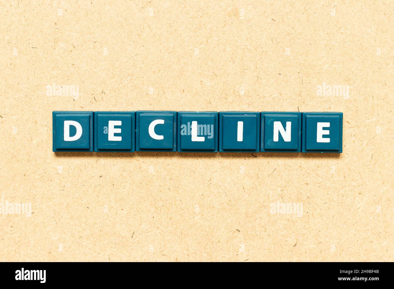 Tile alphabet letter in word decline on wood background Stock Photo - Alamy