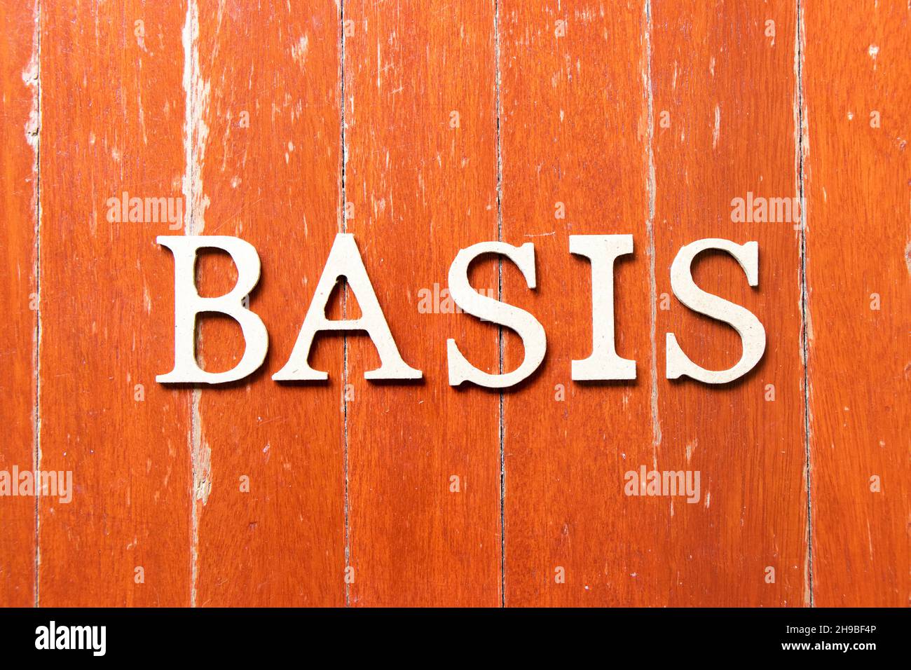 Alphabet letter in word basis on old red color wood plate background ...