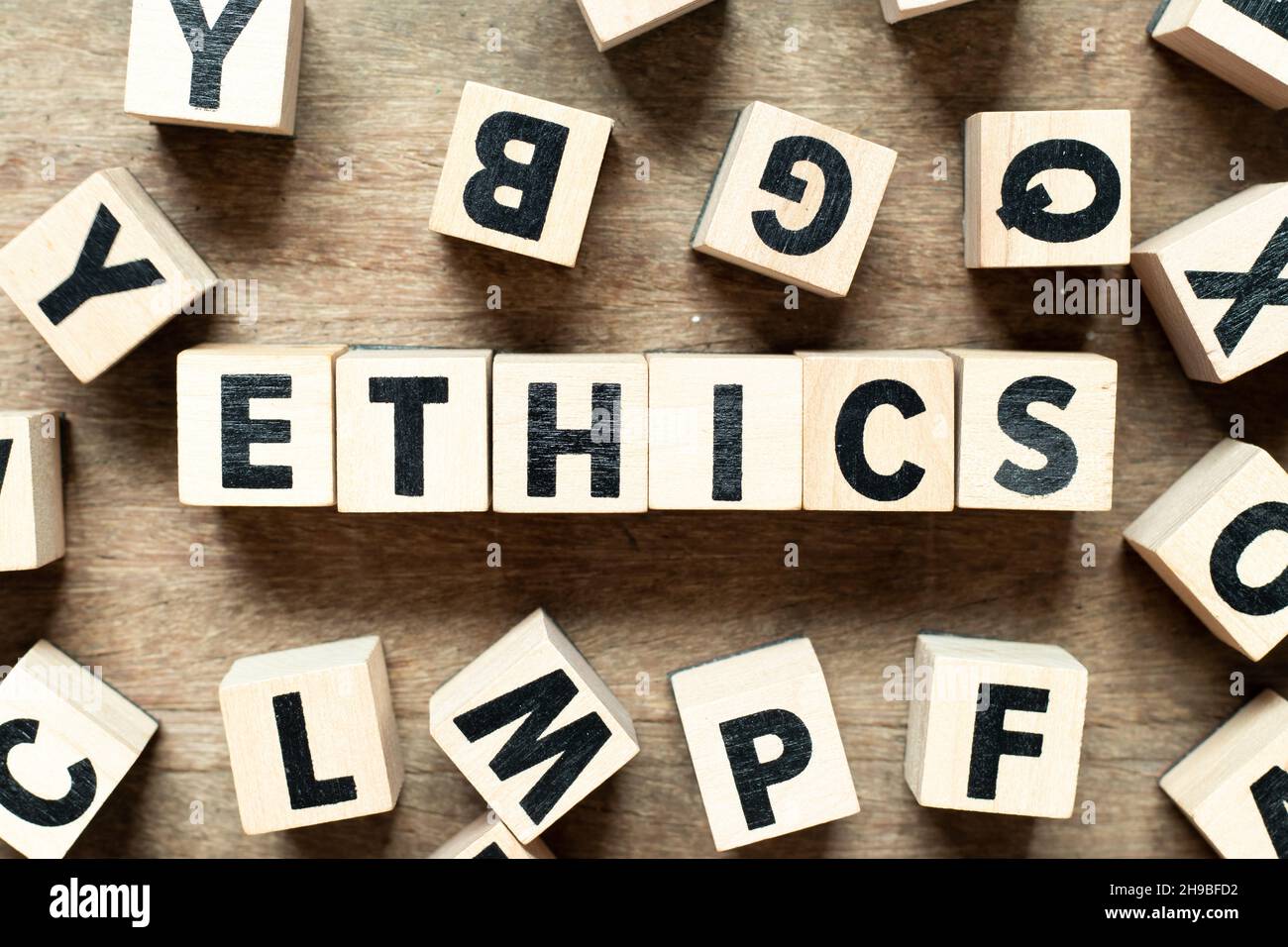 Alphabet letter block in word ethics with another block on wood ...