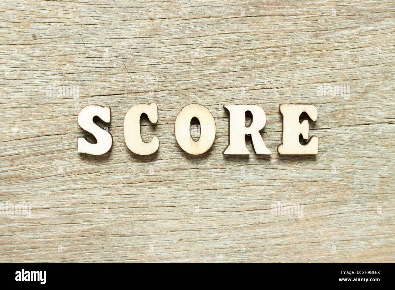 Alphabet letter in word score on wood background Stock Photo - Alamy