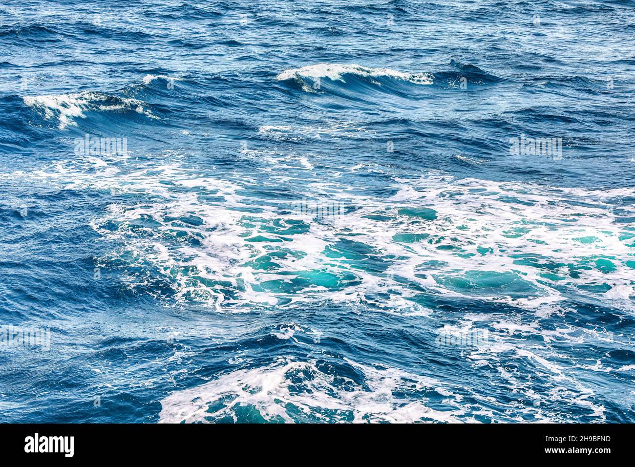 Background shot of aqua sea water surface. Swirling pattern from large ...
