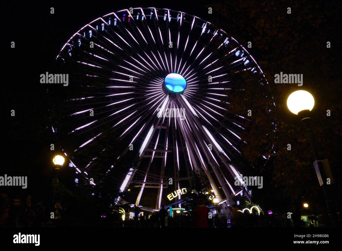 Florence, December 2021: Christmas holidays. Illuminated ferris wheel ...