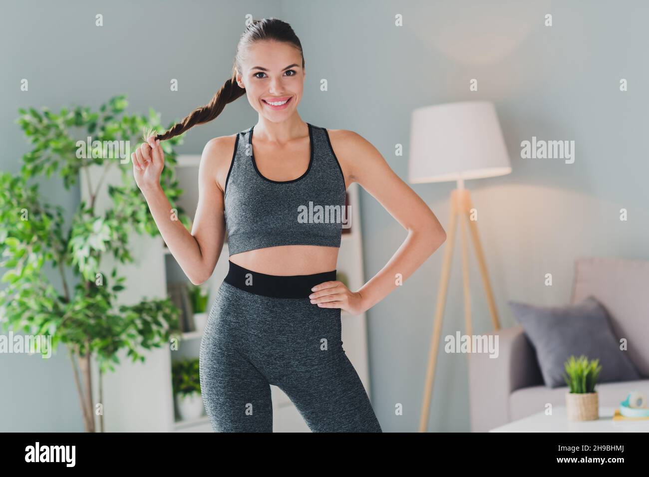 Photo of charming strong girl dressed sport suit arm waist hand tail ...