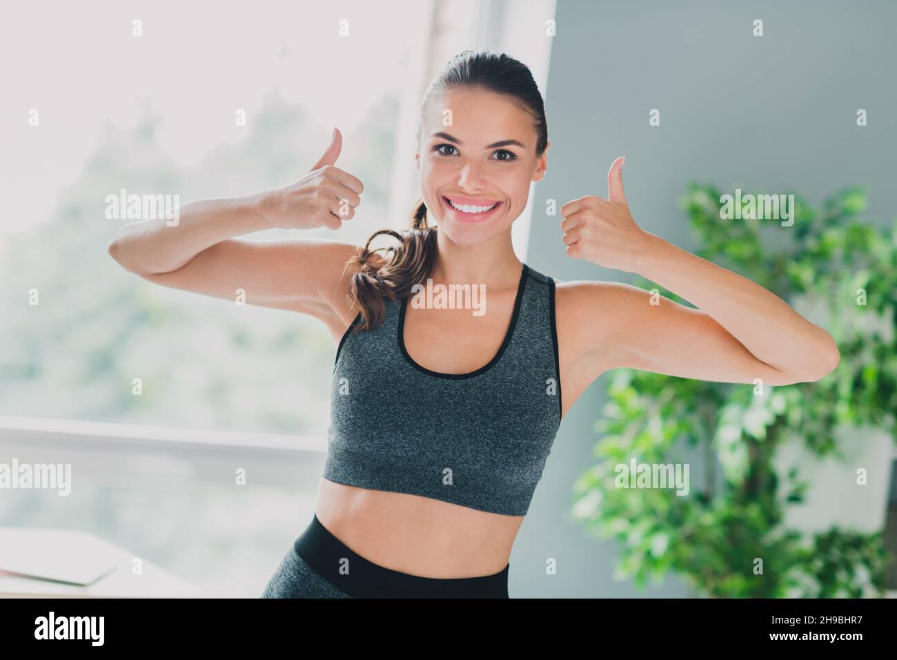 Photo of charming strong lady wear sport outfit showing two thumbs up ...