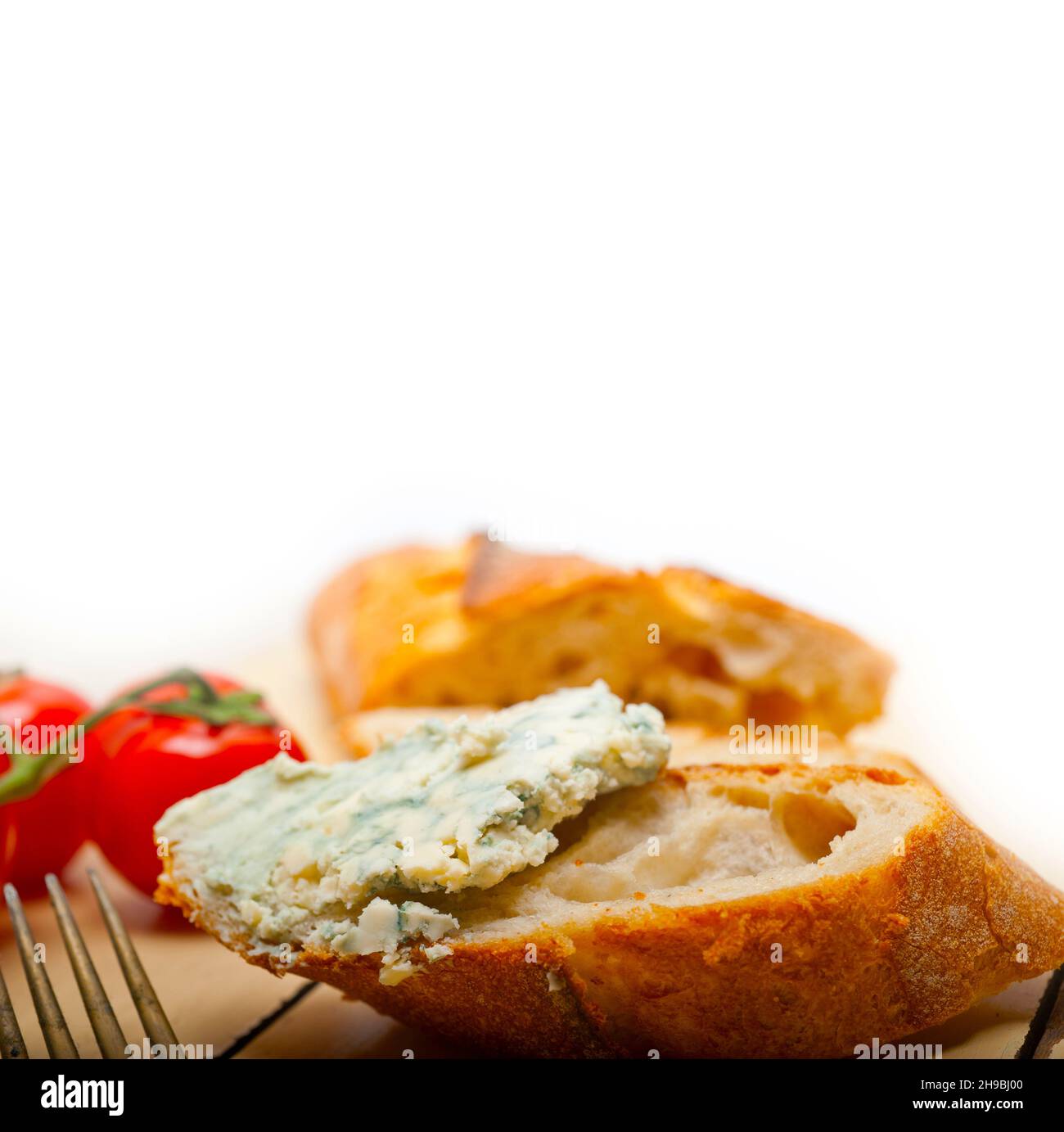 fresh blue cheese spread ove french baguette with cherry tomatoes on ...