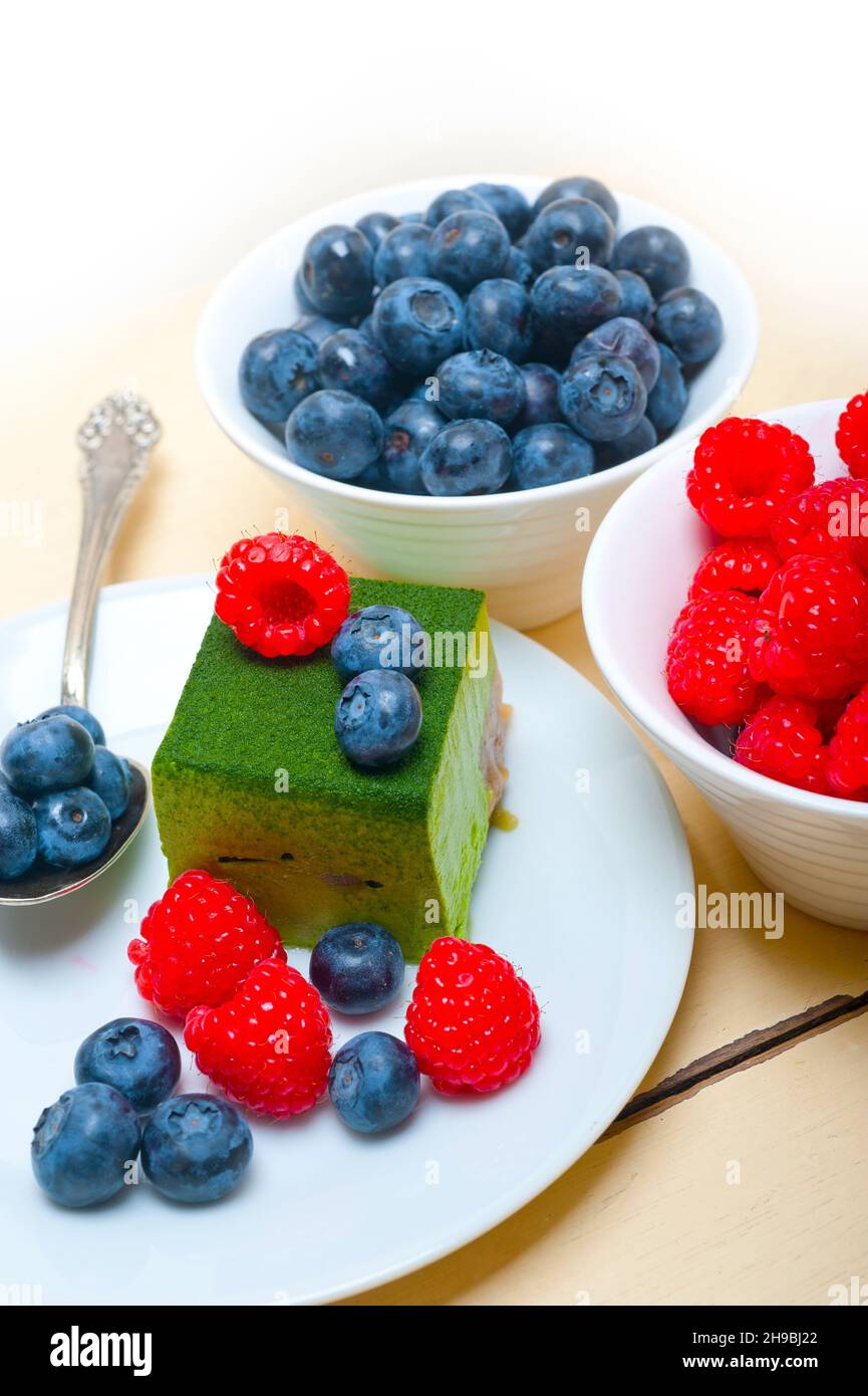 green tea matcha mousse cake with raspberries and blueberries on top ...