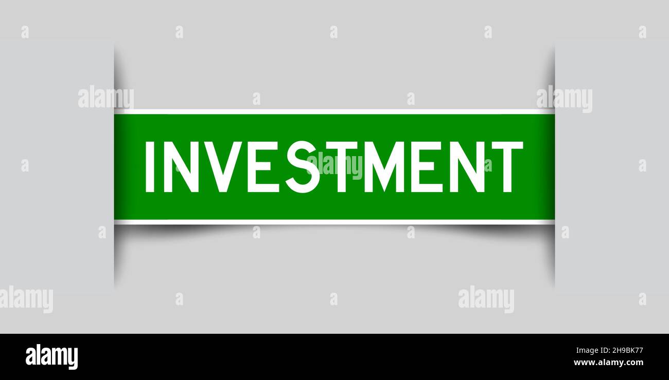 Inserted green color label sticker with word investment on gray ...