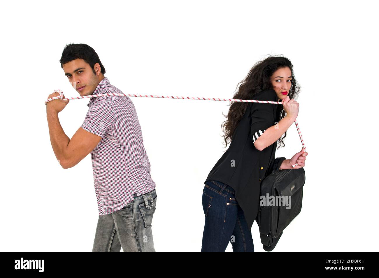 Working class man and business woman pulling in an opposite direction ...