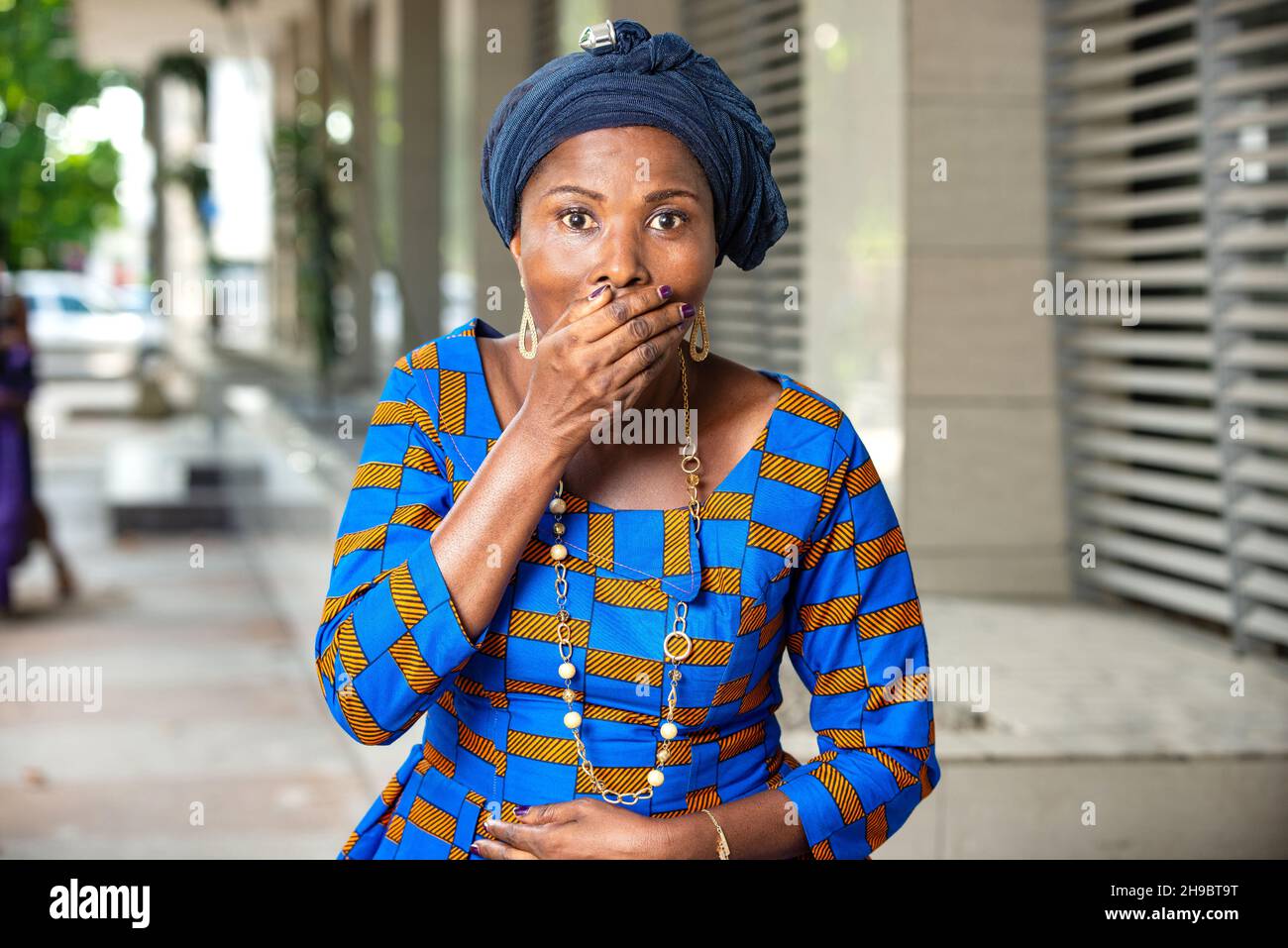 African woman hand over mouth hi-res stock photography and images - Alamy