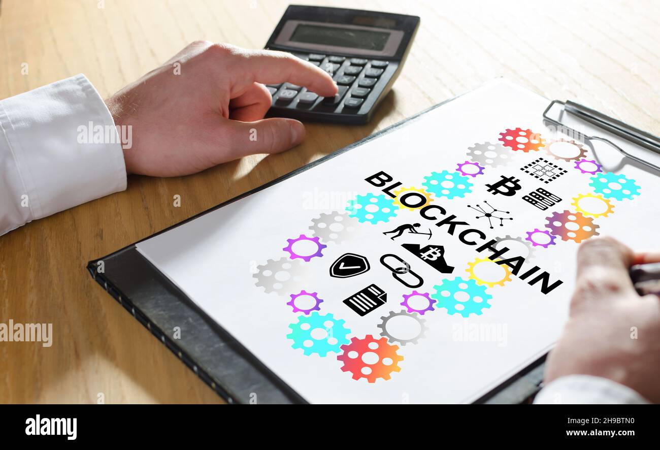 Blockchain concept with hand using a calculator Stock Photo - Alamy