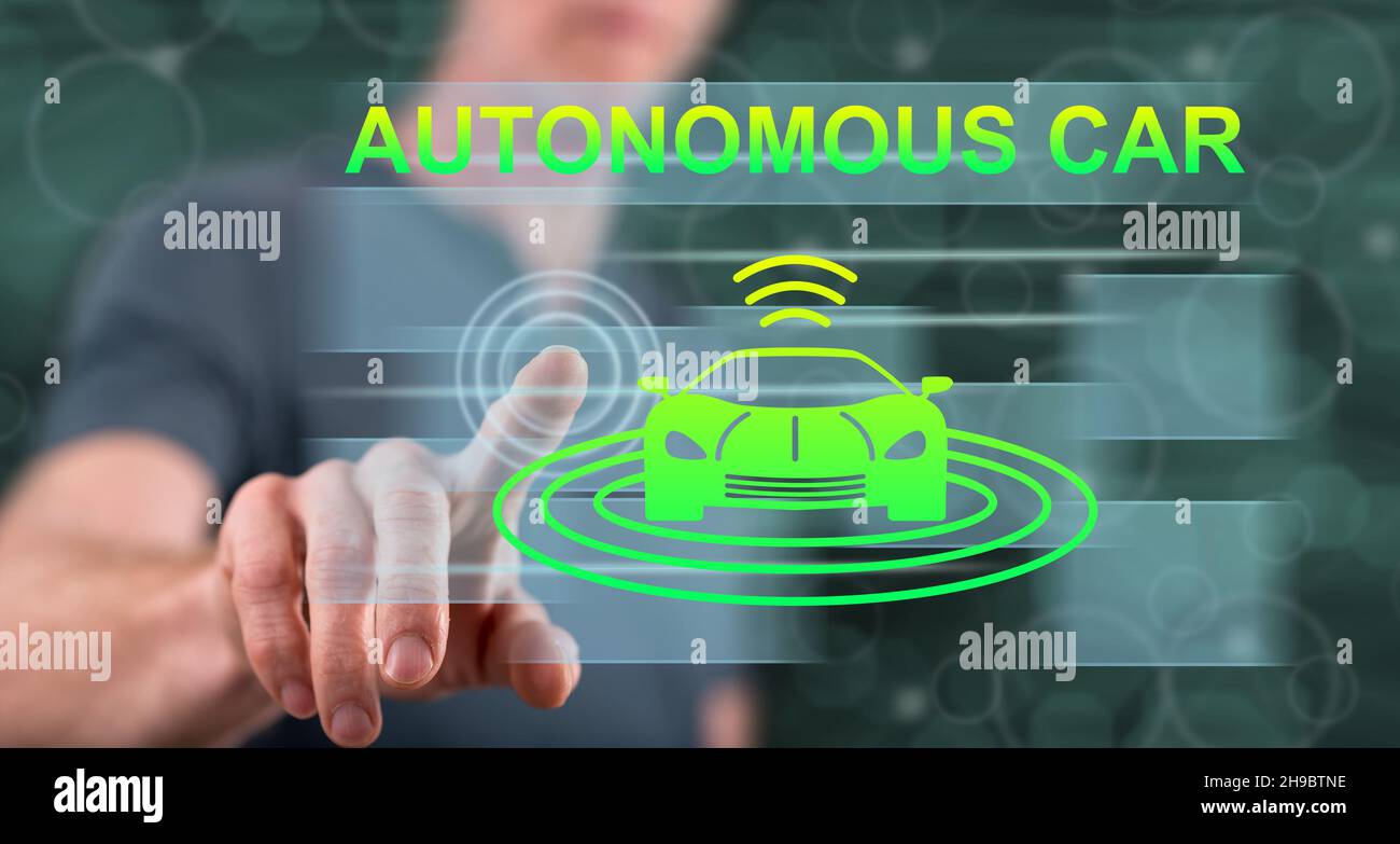Man touching an autonomous car concept on a touch screen with his ...